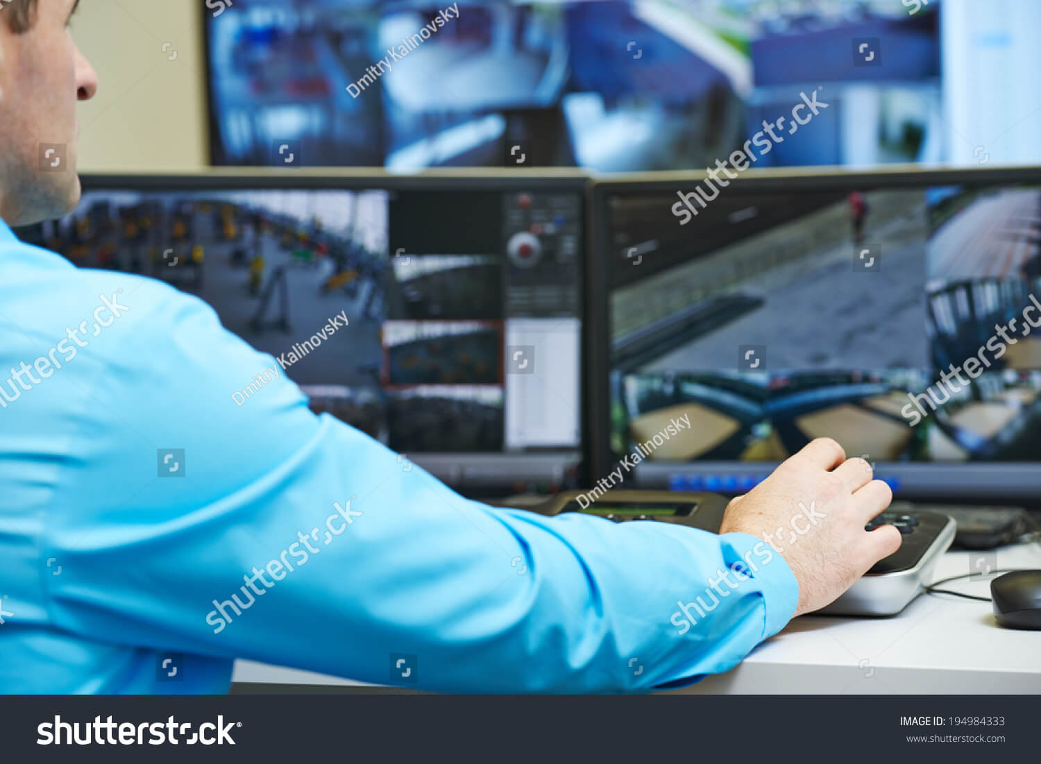stock-photo-security-guard-watching-and-operating-video-monitoring ...